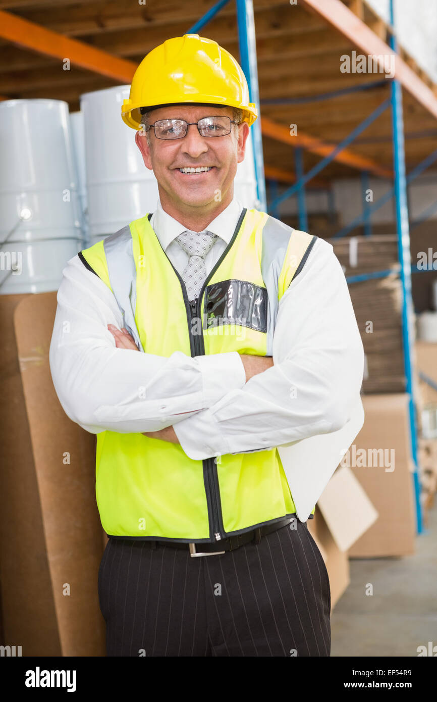 Manager wearing hard hat in warehouse Stock Photo - Alamy