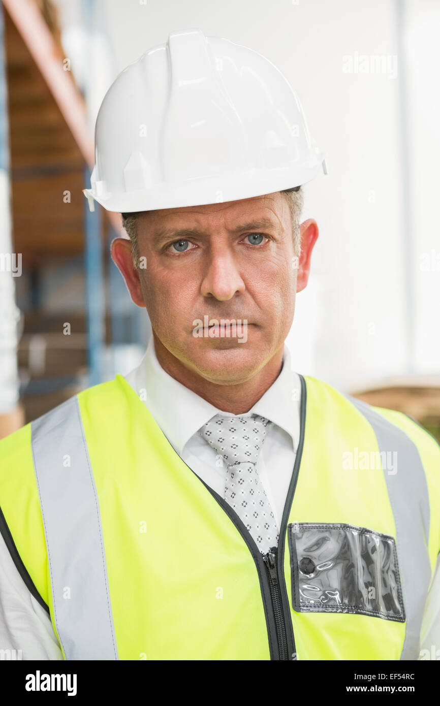 Manager wearing hard hat in warehouse Stock Photo - Alamy