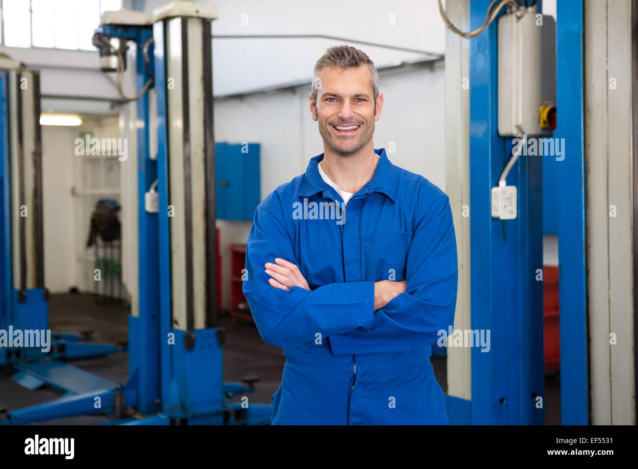 Mechanic smiling at the camera Stock Photo - Alamy