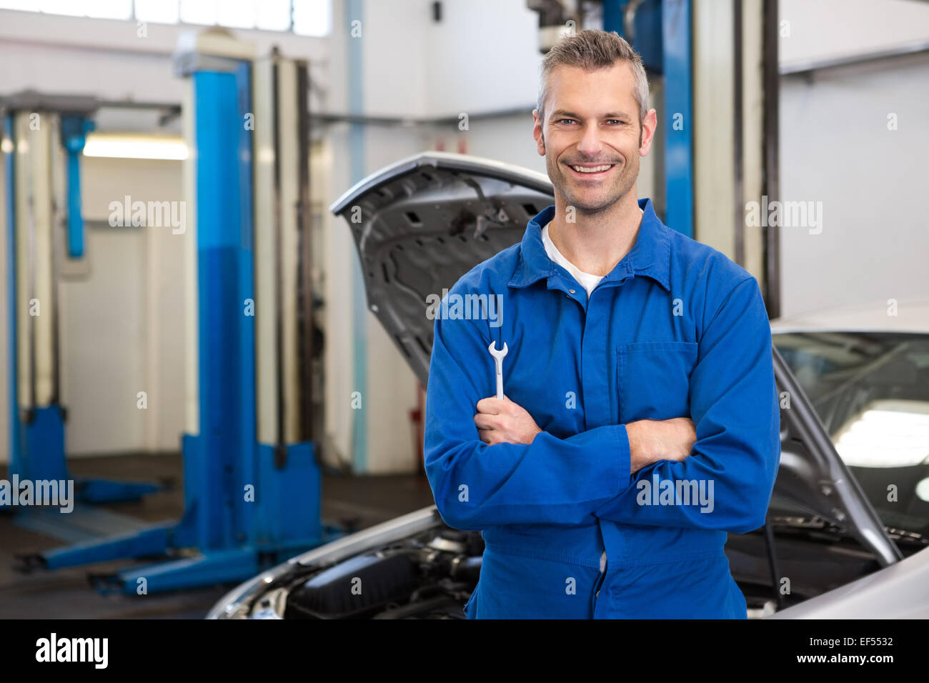 Mechanic smiling at the camera Stock Photo - Alamy