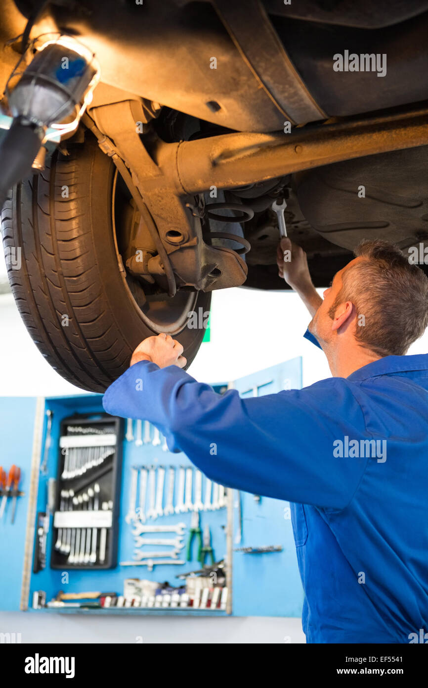 Mechanic examining under the car Stock Photo - Alamy