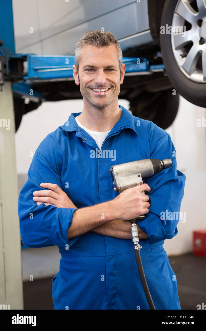 Mechanic holding a drill tool Stock Photo - Alamy