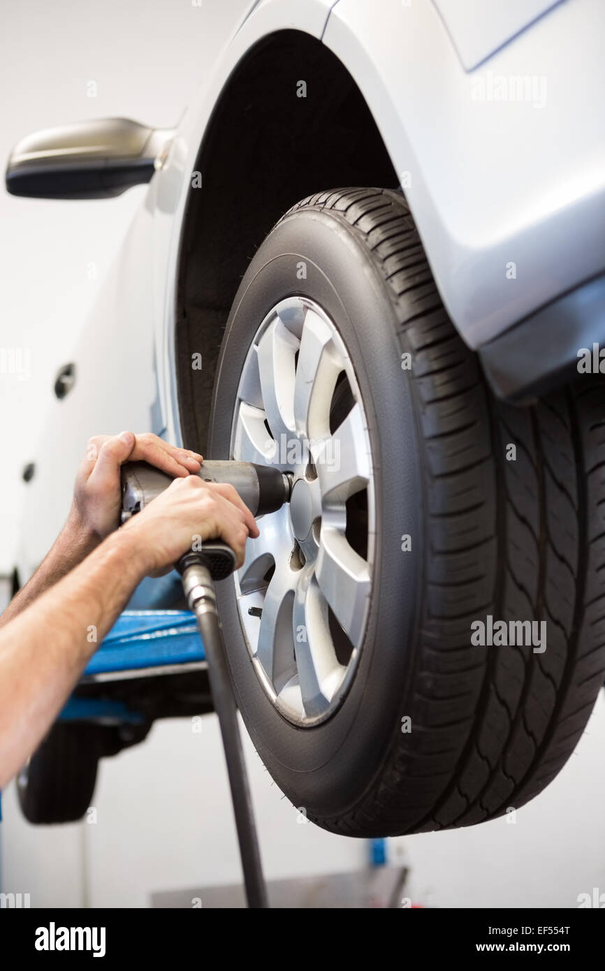 Mechanic adjusting the tire wheel Stock Photo - Alamy