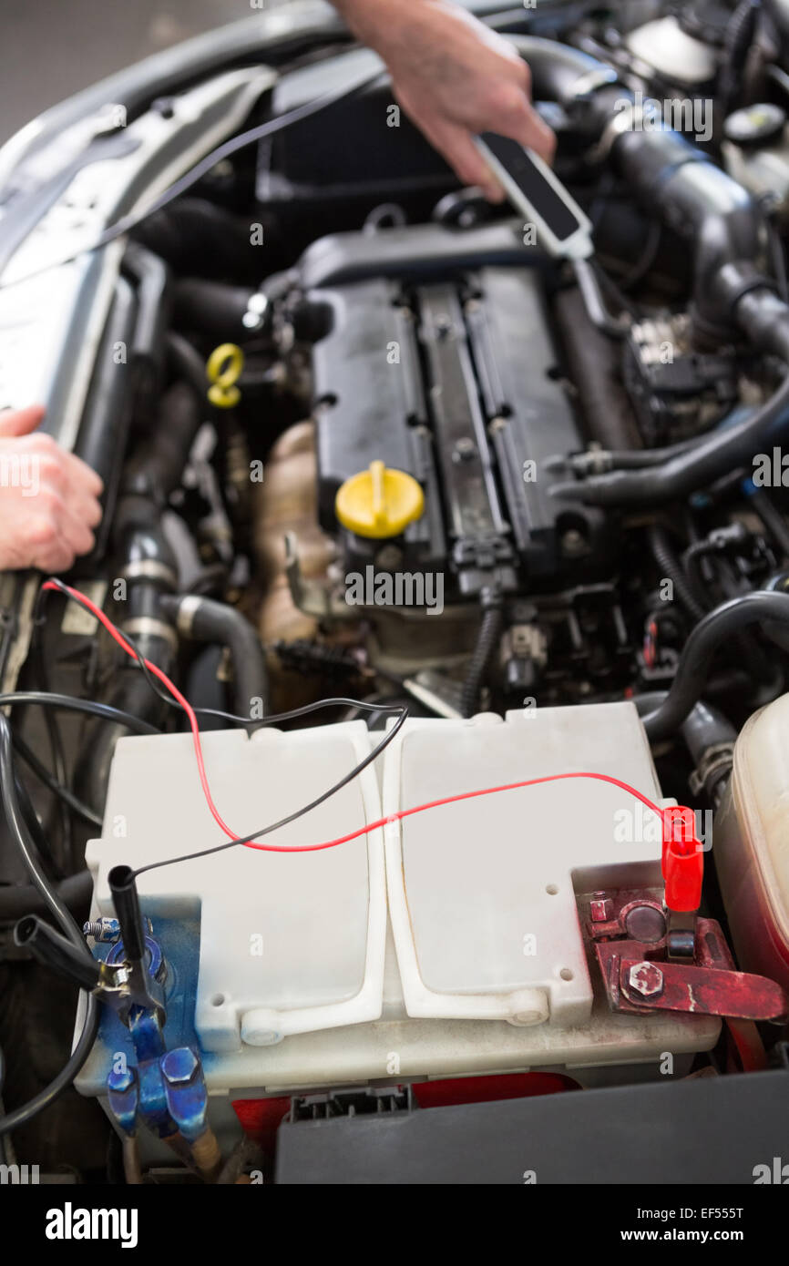 Mechanic working under the hood Stock Photo - Alamy