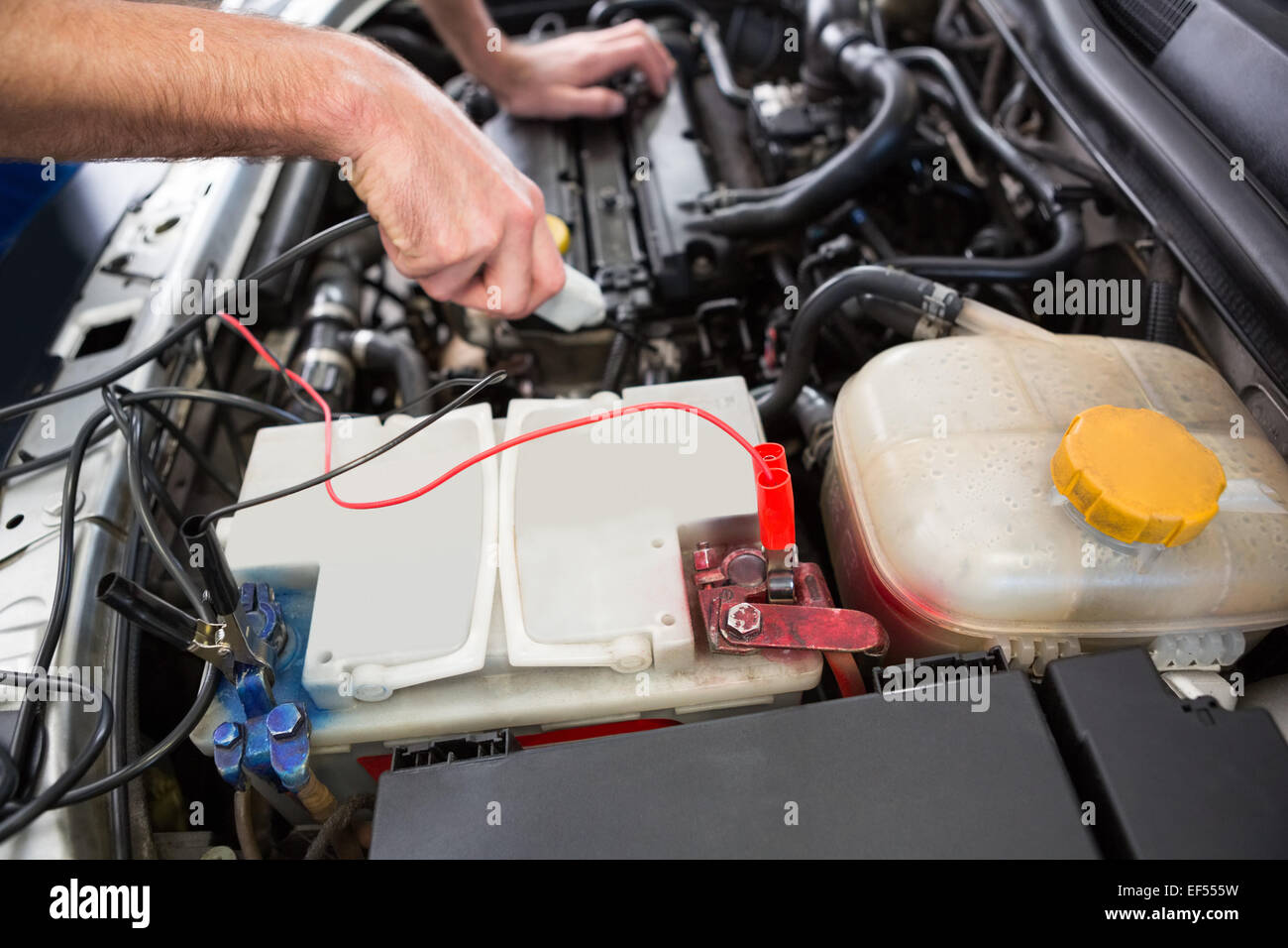 Mechanic working under the hood Stock Photo - Alamy