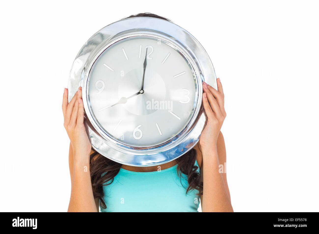 Pretty brunette holding a clock Stock Photo - Alamy