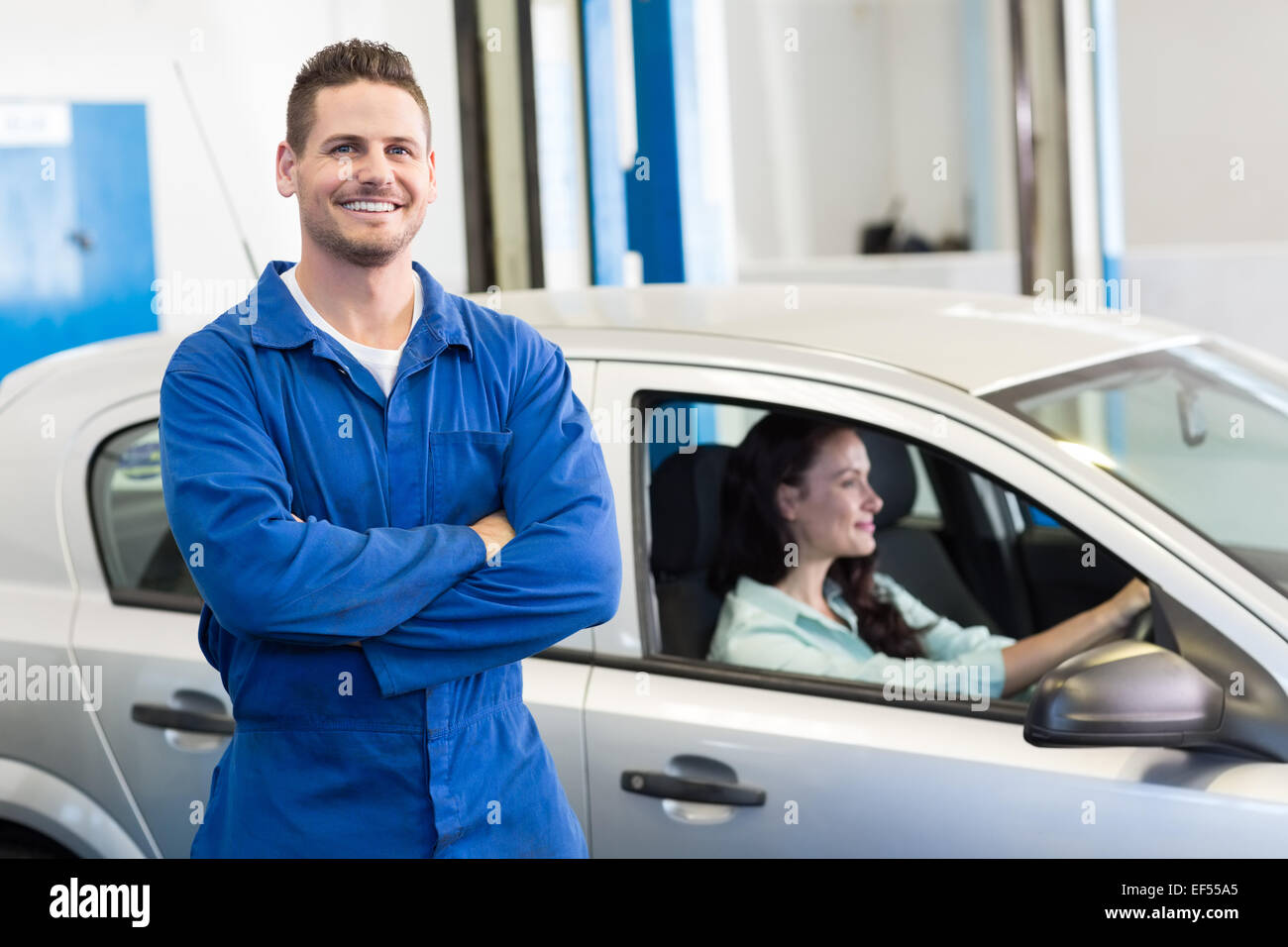 Mechanic smiling at the camera Stock Photo - Alamy