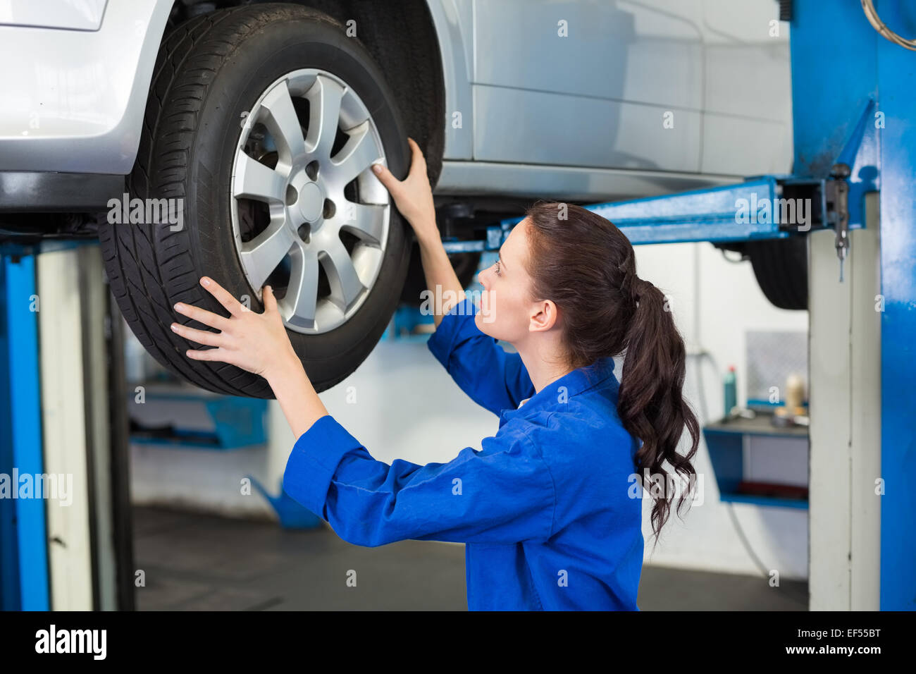 Mechanic adjusting the tire wheel Stock Photo - Alamy