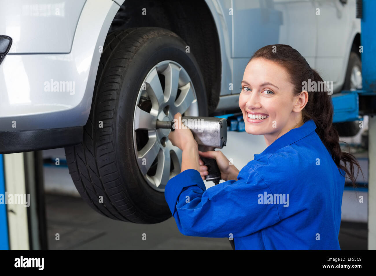 Mechanic adjusting the tire wheel Stock Photo - Alamy