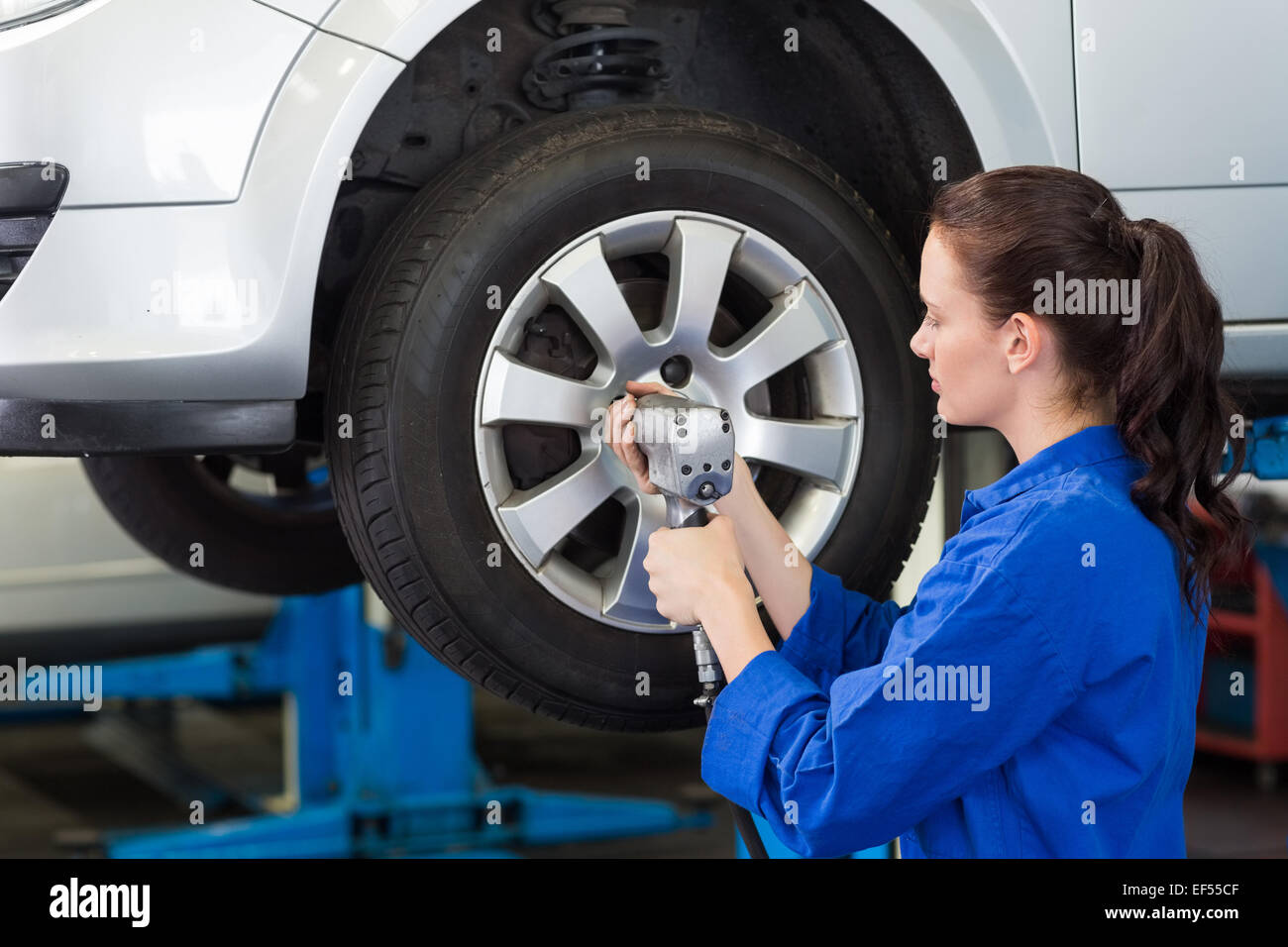 Mechanic adjusting the tire wheel Stock Photo - Alamy