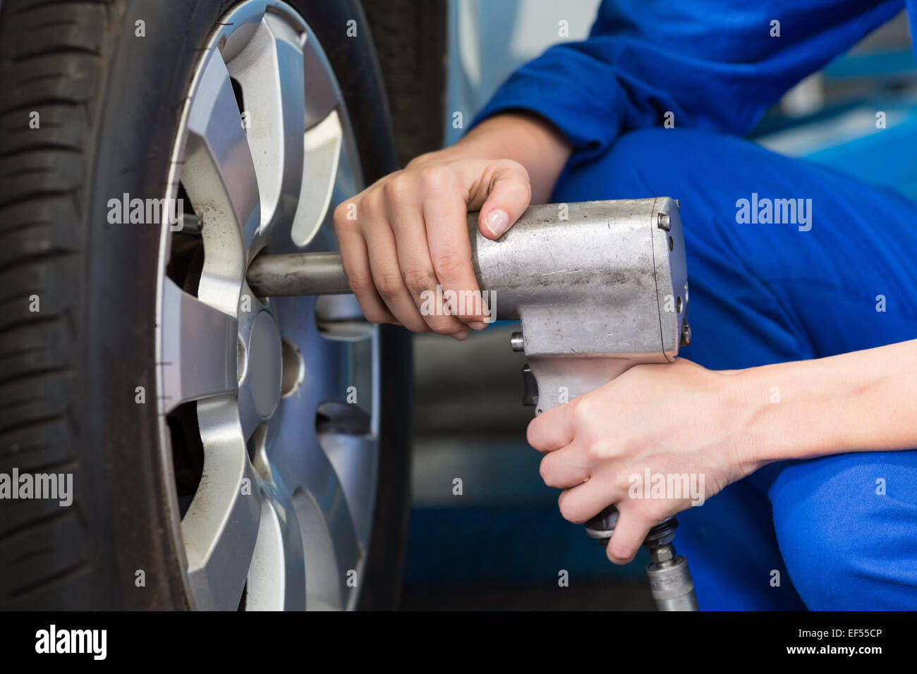 Mechanic adjusting the tire wheel Stock Photo - Alamy