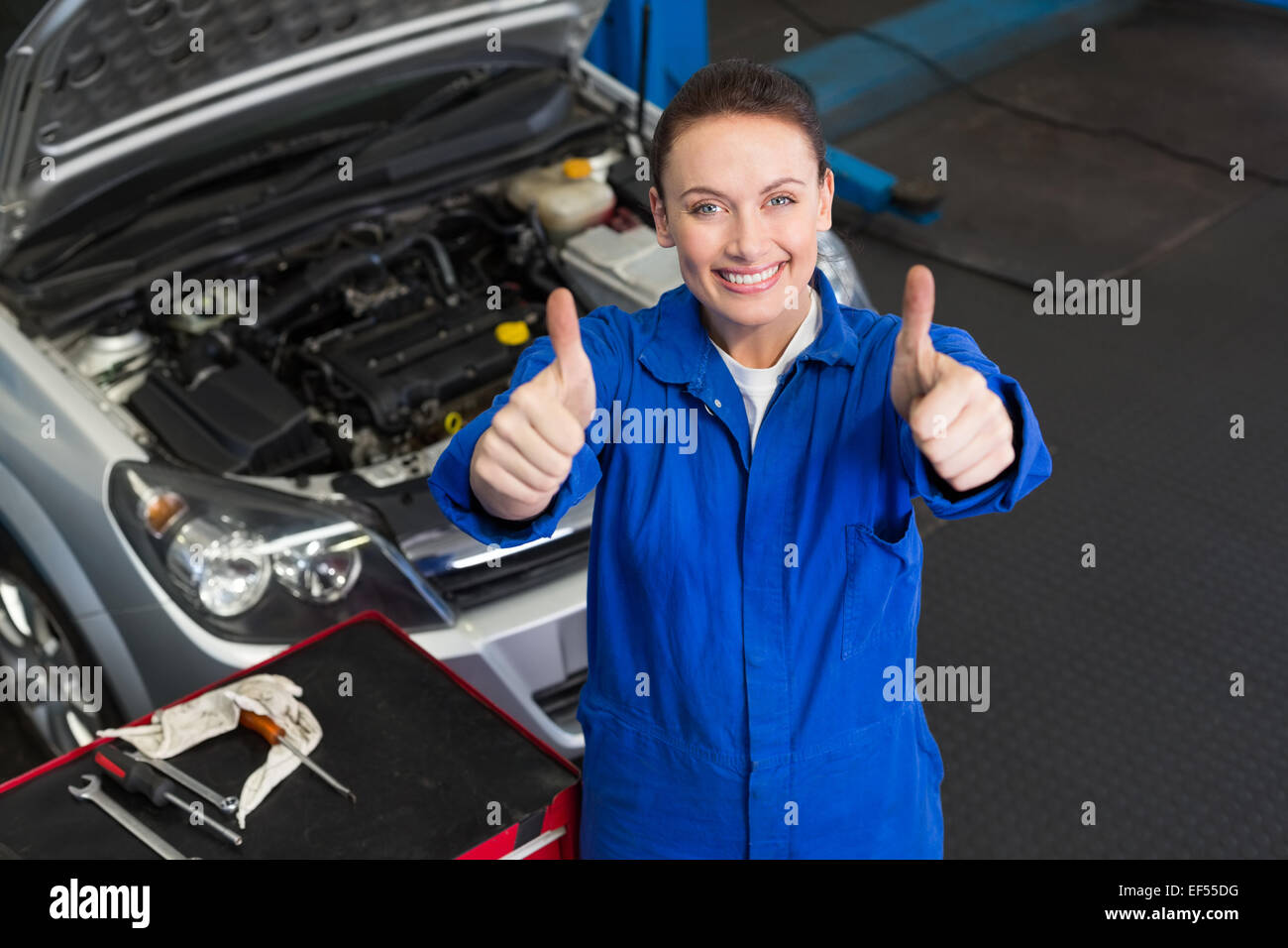 Mechanic looking up at camera Stock Photo - Alamy