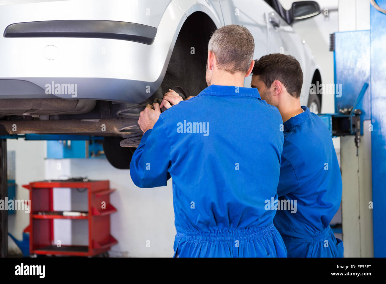Team of mechanics working together Stock Photo - Alamy