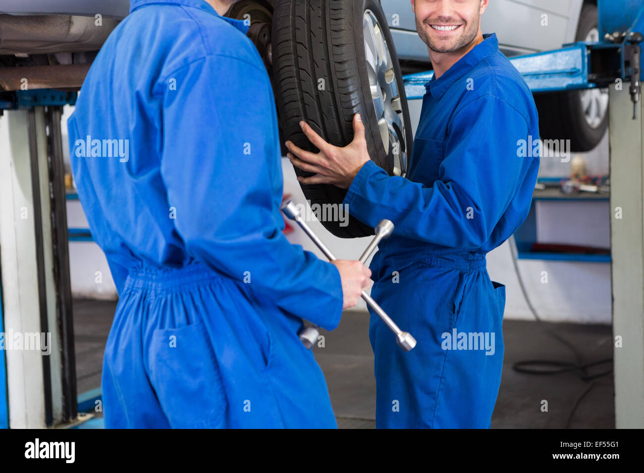 Team of mechanics working together Stock Photo - Alamy