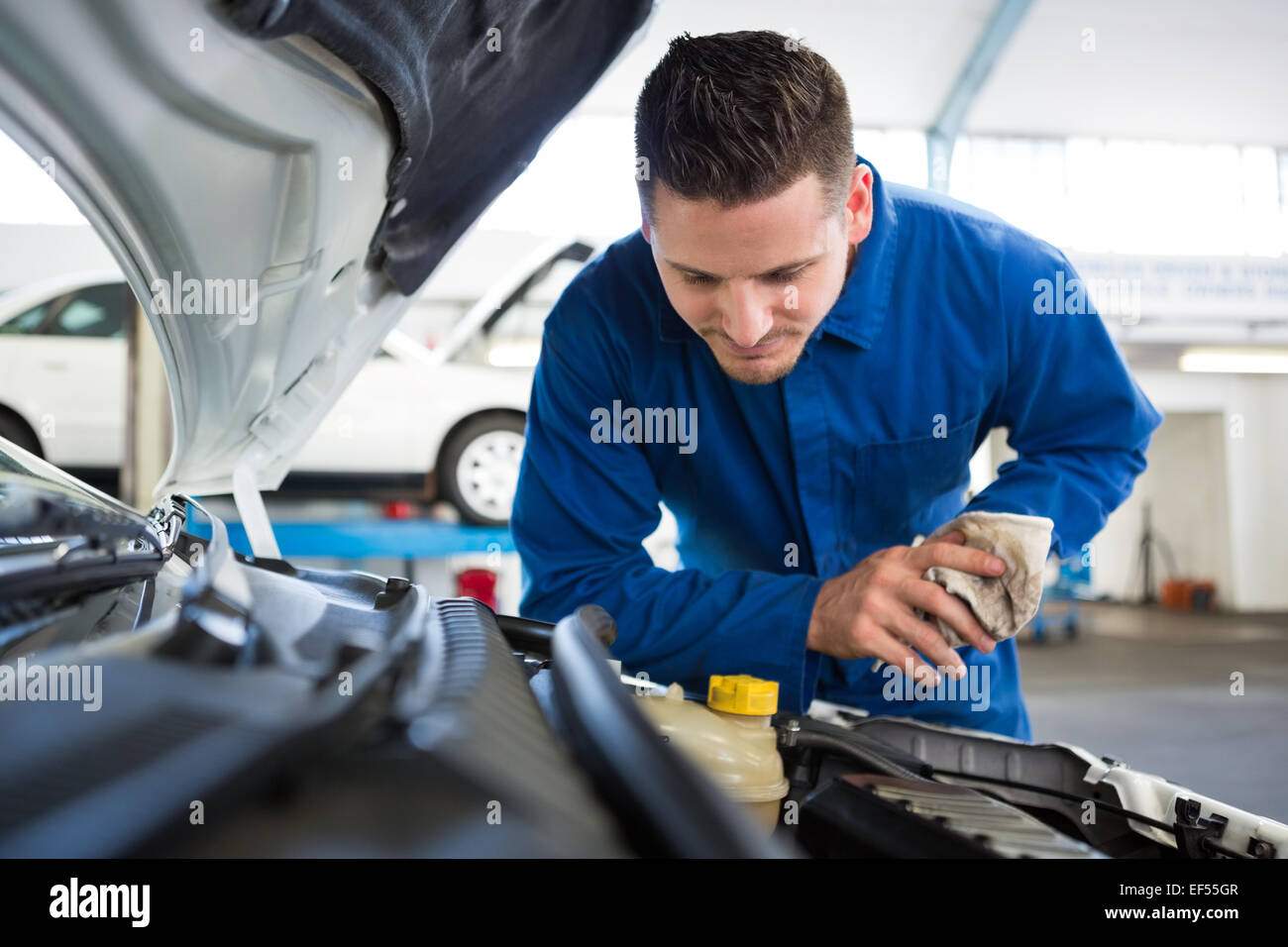 Mechanic working under the hood Stock Photo - Alamy