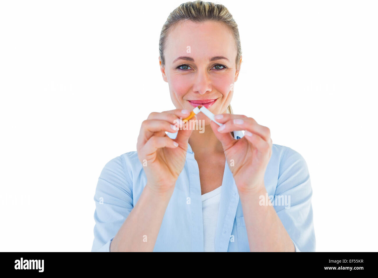 Smiling blonde standing and breaking cigarette Stock Photo - Alamy