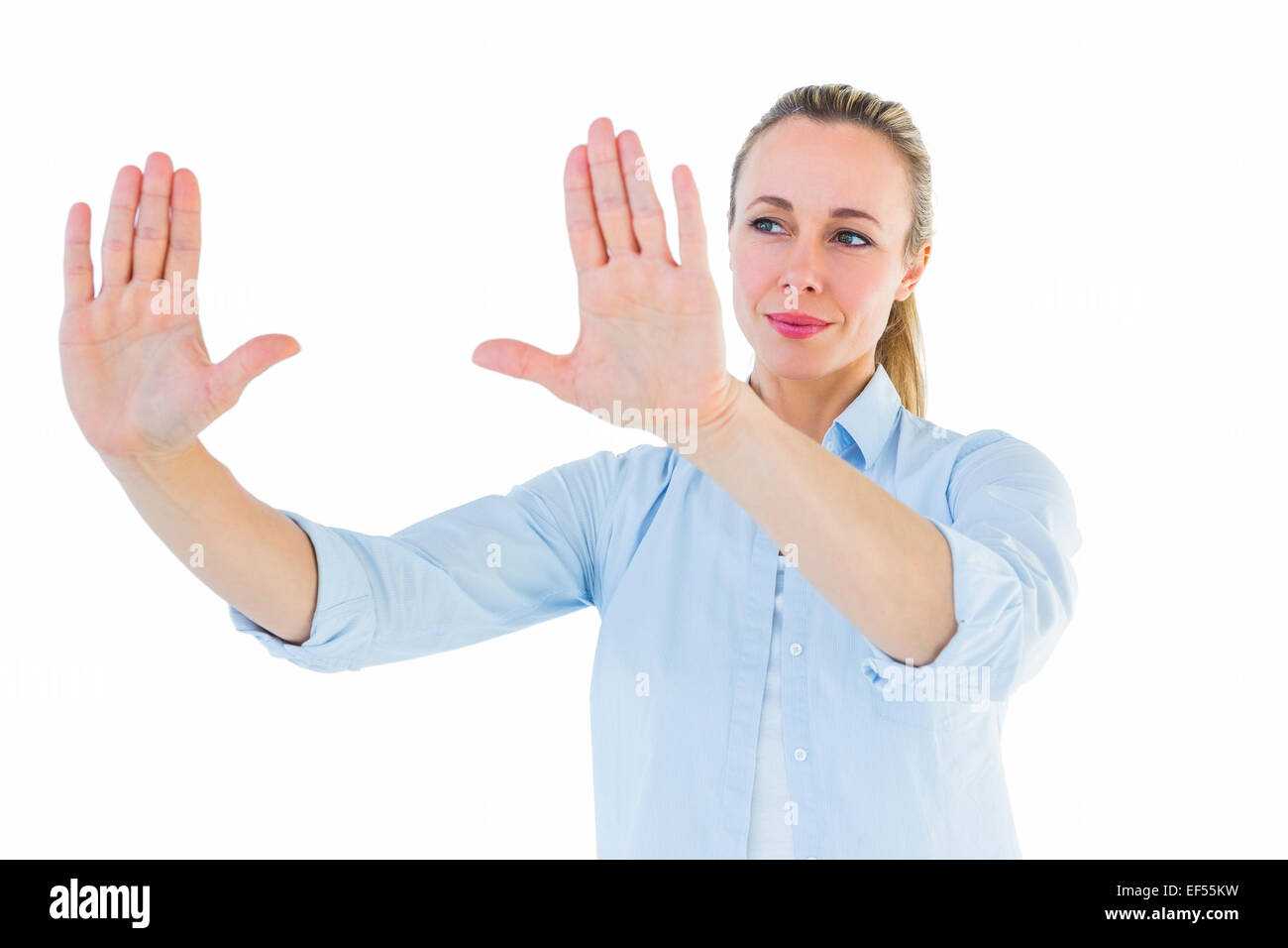 Smiling blonde making a hand gesture Stock Photo - Alamy
