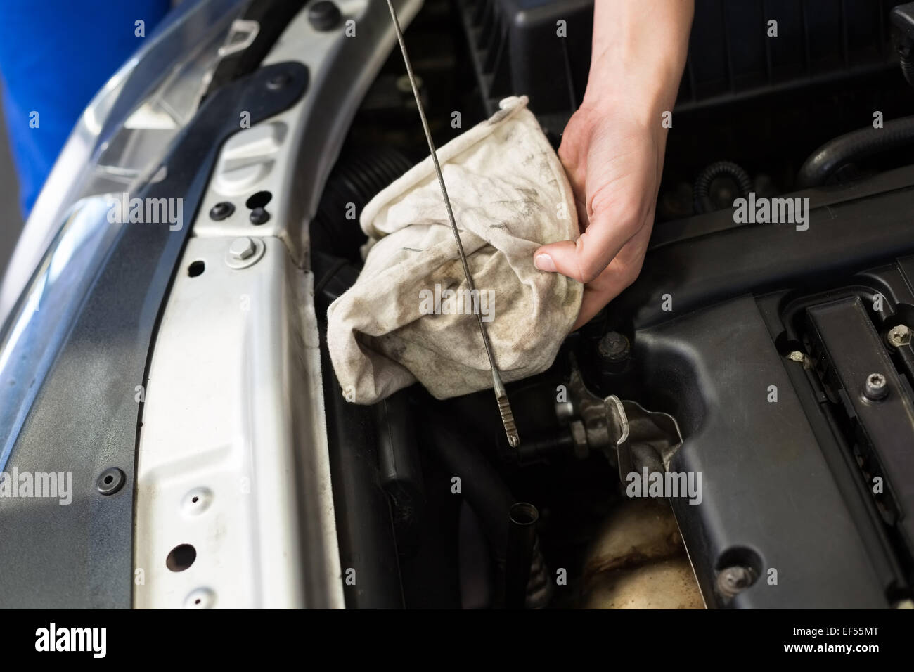 Woman checking car engine oil hi-res stock photography and images - Alamy