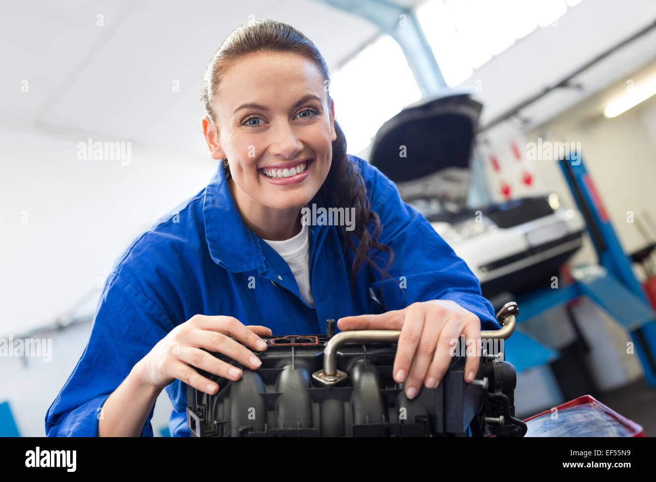 Mechanic working on an engine Stock Photo - Alamy