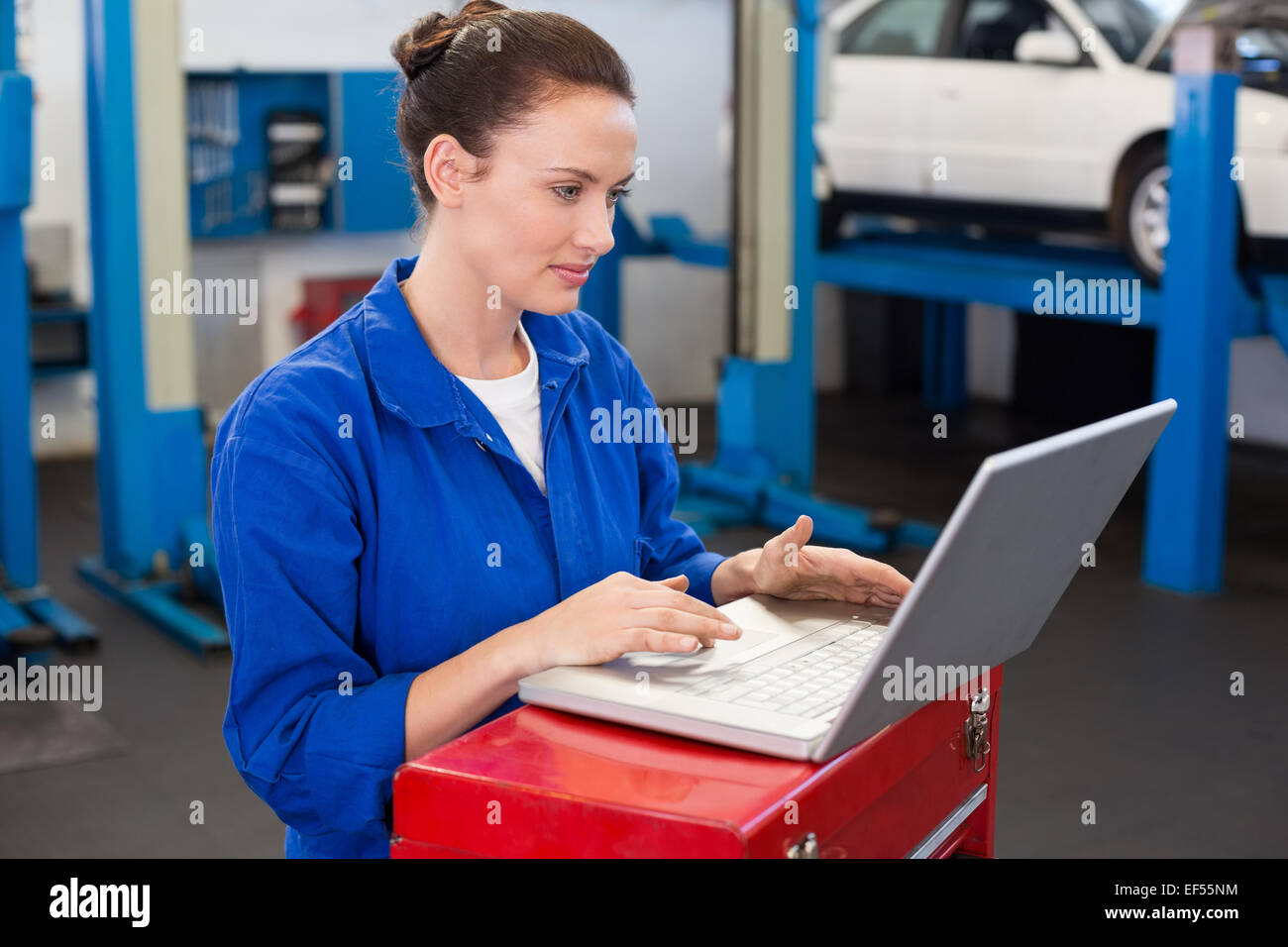 Mechanic working on a laptop Stock Photo - Alamy