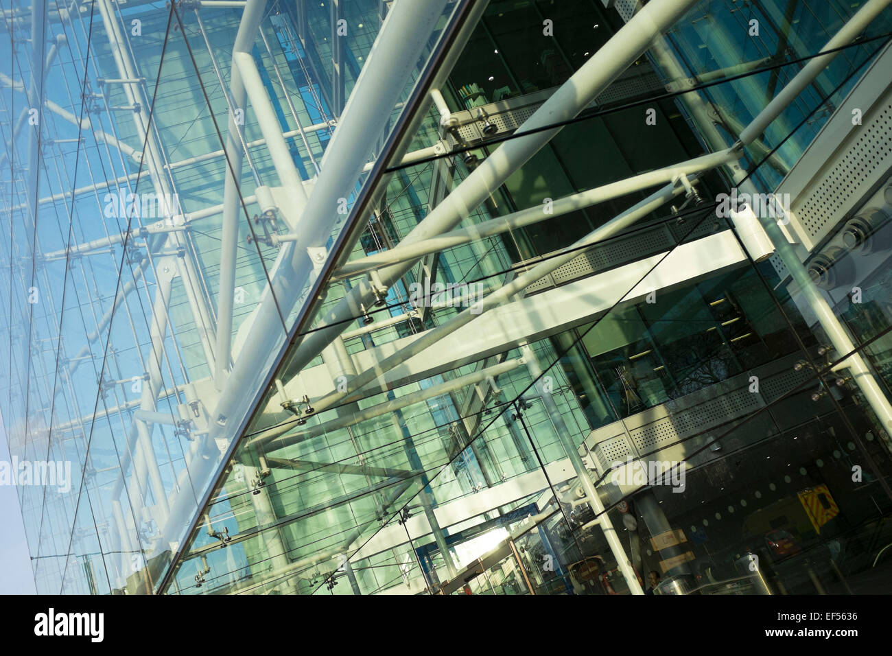 Reflections in a modern glass building. This architecture example is of ...