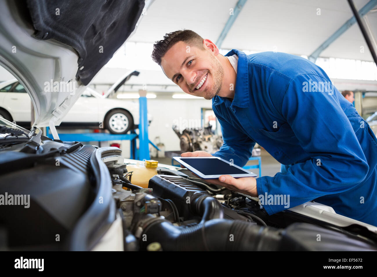 Happy car mechanic tablet pc hi-res stock photography and images - Alamy