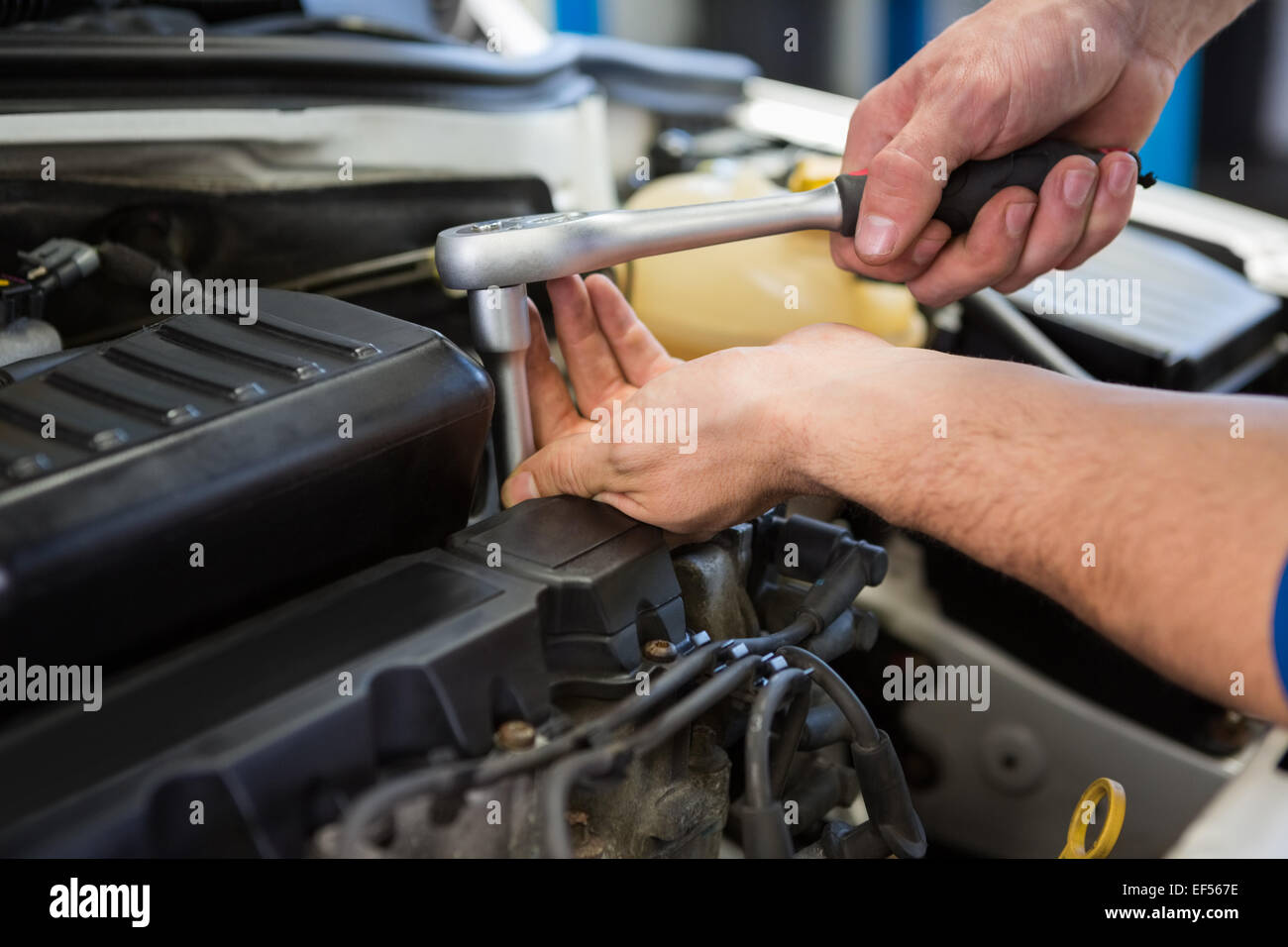 Mechanic working on an engine Stock Photo - Alamy