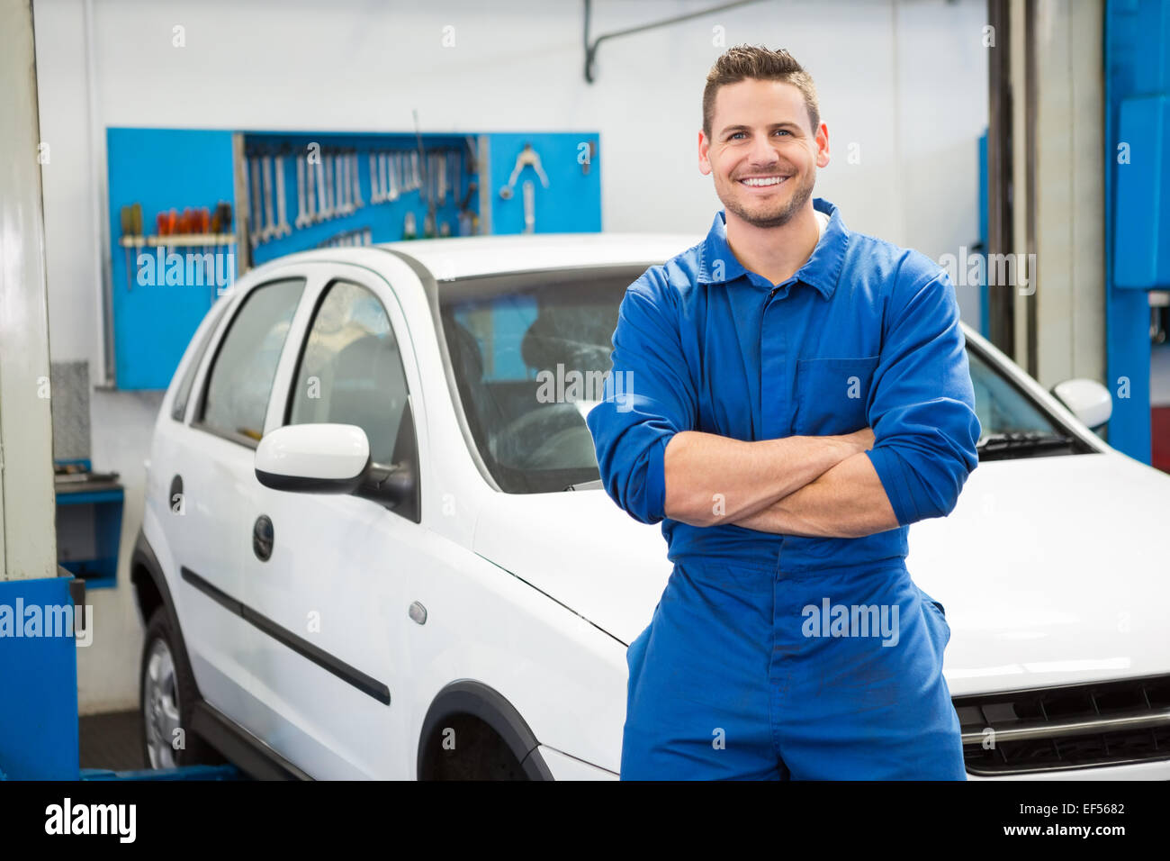 Mechanic smiling at the camera Stock Photo - Alamy