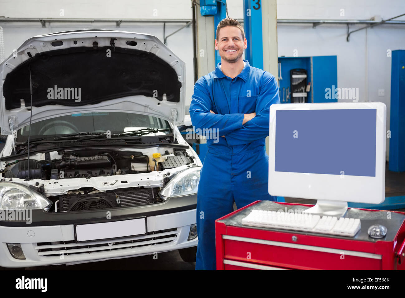 Mechanic smiling at the camera Stock Photo - Alamy