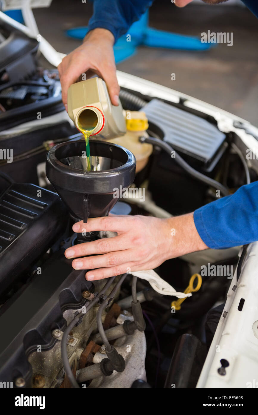 Mechanic pouring oil car hi-res stock photography and images - Alamy