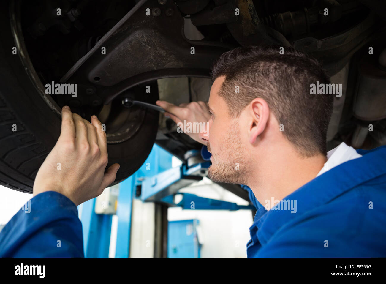 Mechanic adjusting the tire wheel Stock Photo - Alamy