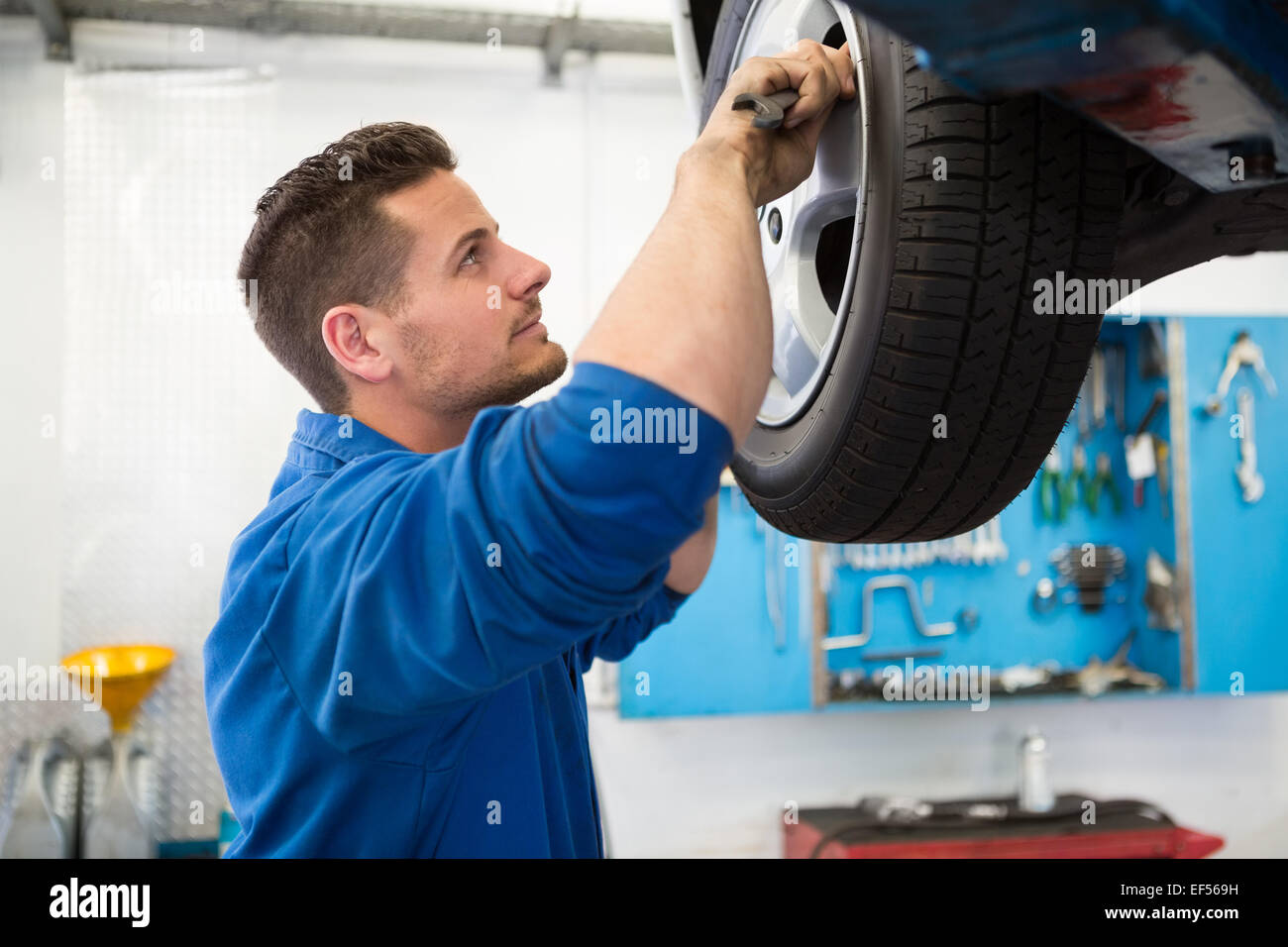 Mechanic adjusting the tire wheel Stock Photo - Alamy