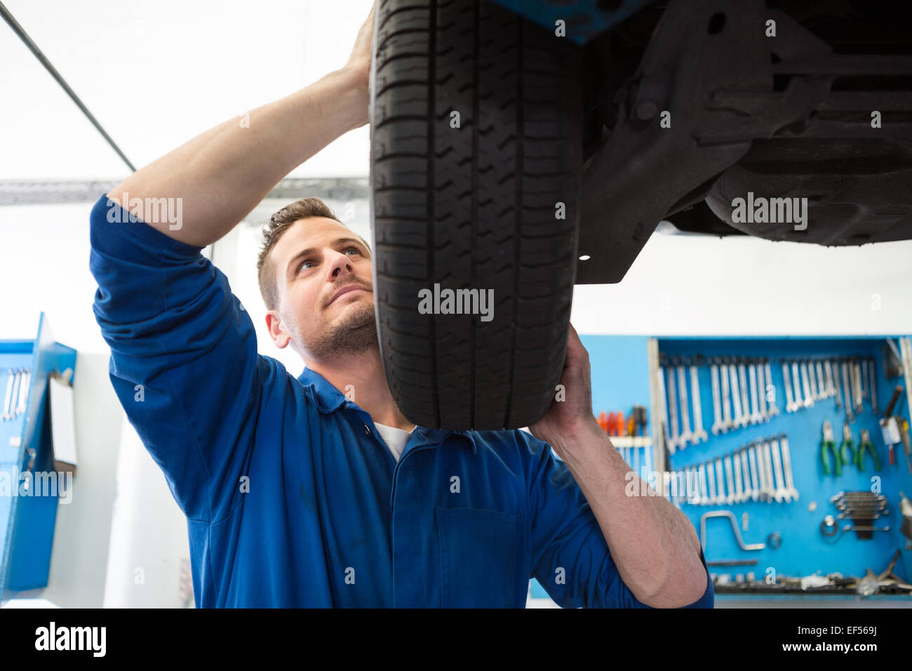 Mechanic adjusting the tire wheel Stock Photo - Alamy