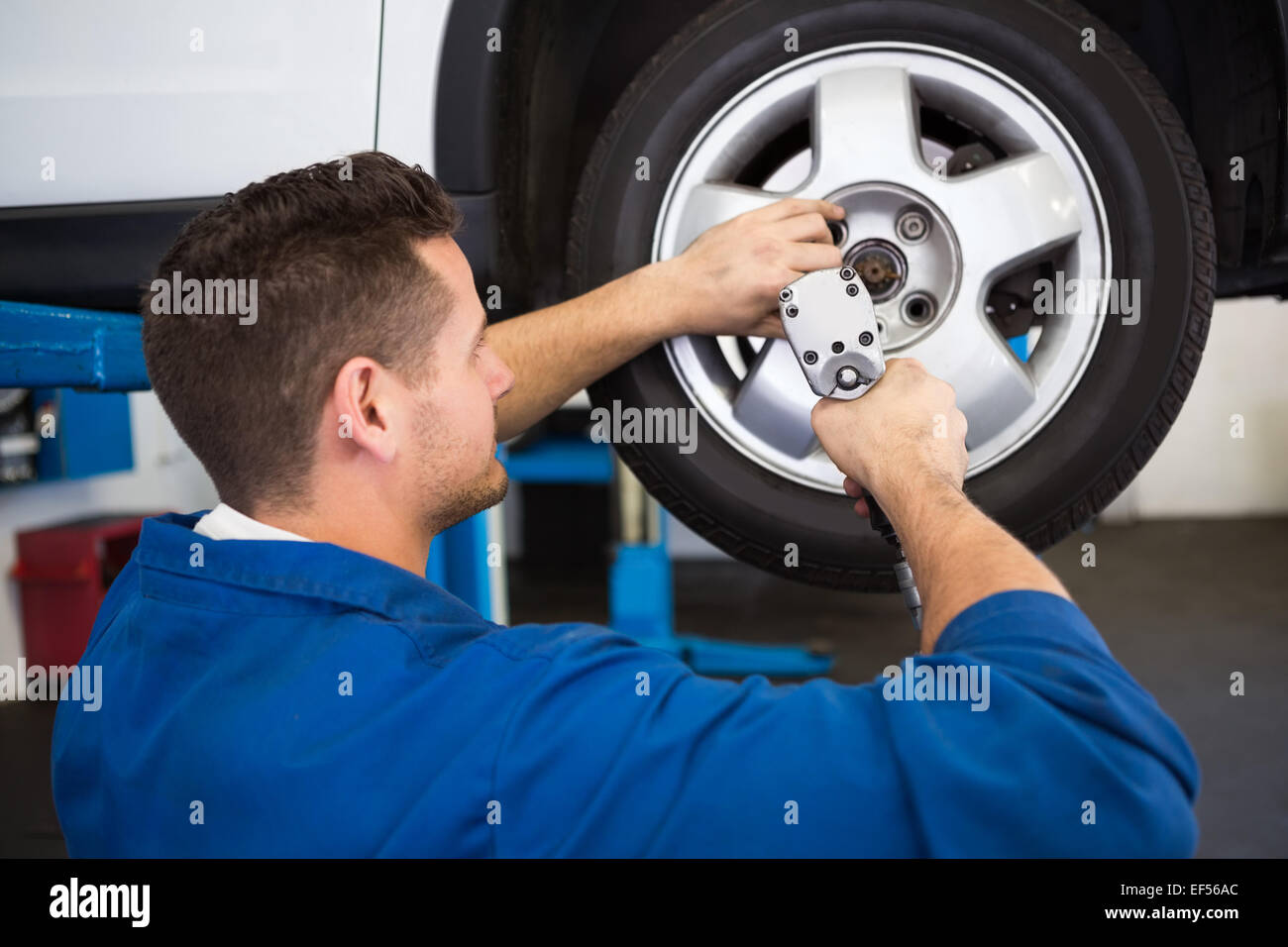 Mechanic adjusting the tire wheel Stock Photo - Alamy