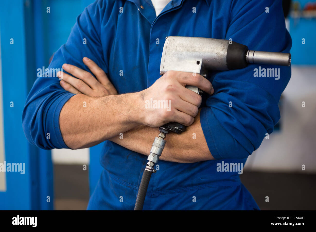 Mechanic holding a drill tool Stock Photo - Alamy