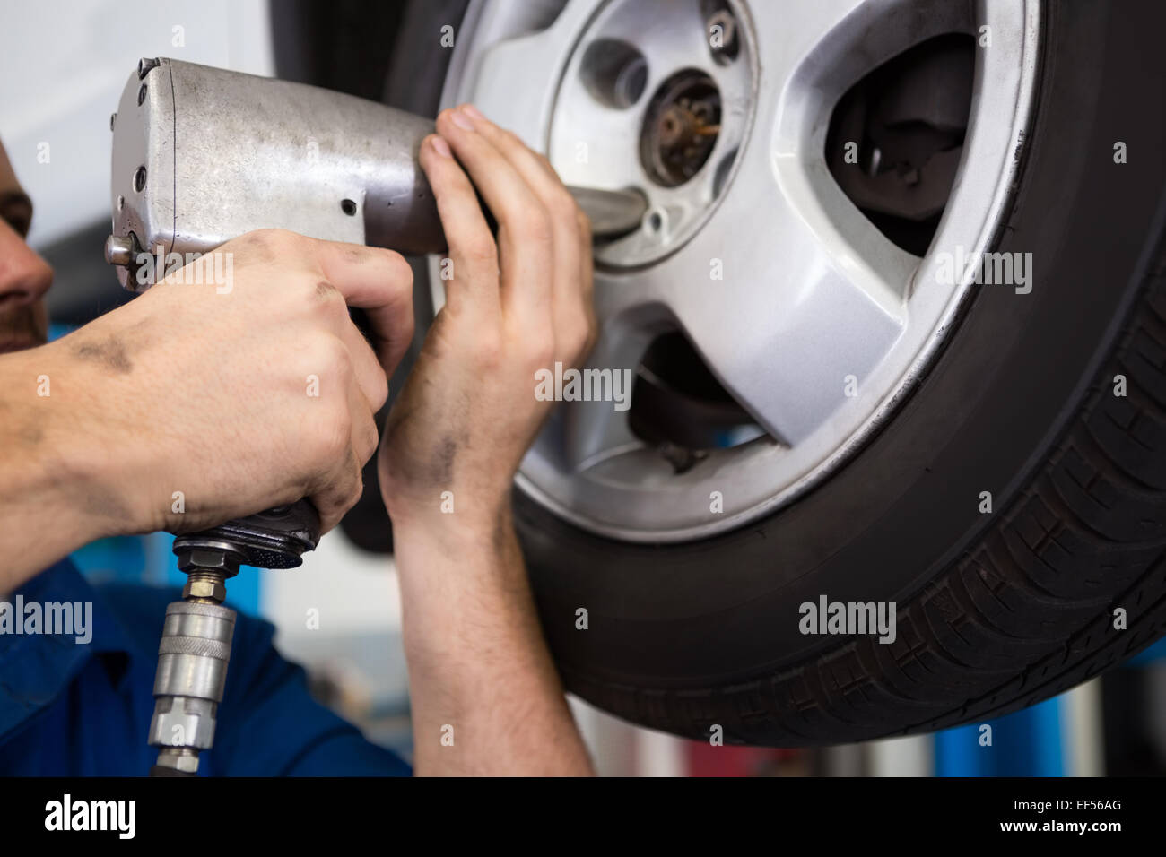 Mechanic adjusting the tire wheel Stock Photo - Alamy