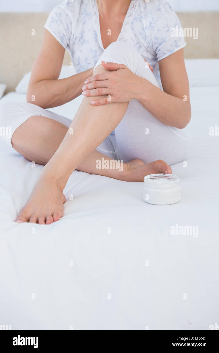 Woman putting cream on her skin Stock Photo - Alamy