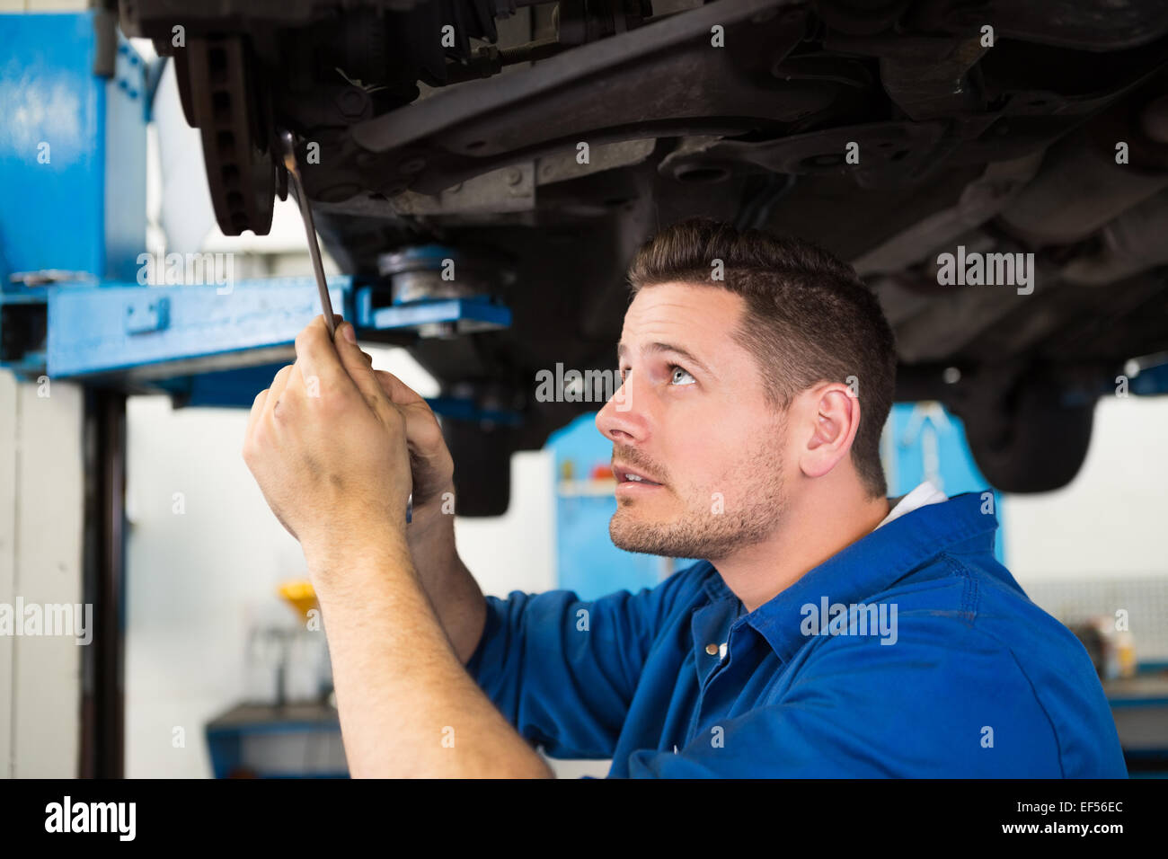 Focused mechanic adjusting the wheel Stock Photo - Alamy