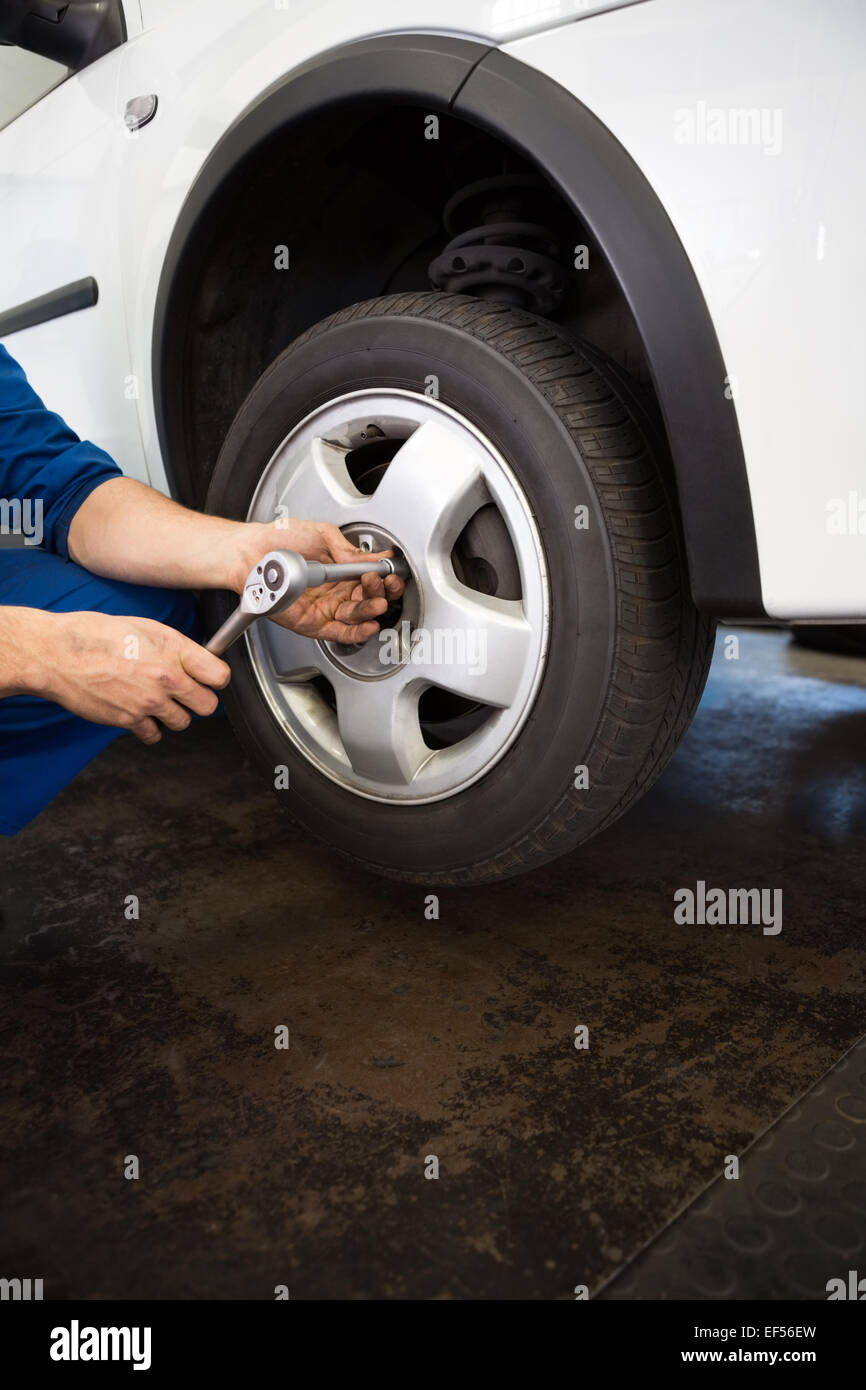Mechanic adjusting the tire wheel Stock Photo - Alamy