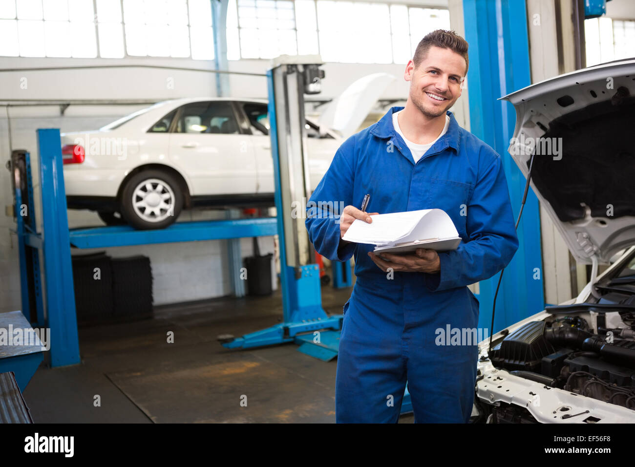 Smiling mechanic looking at camera Stock Photo - Alamy