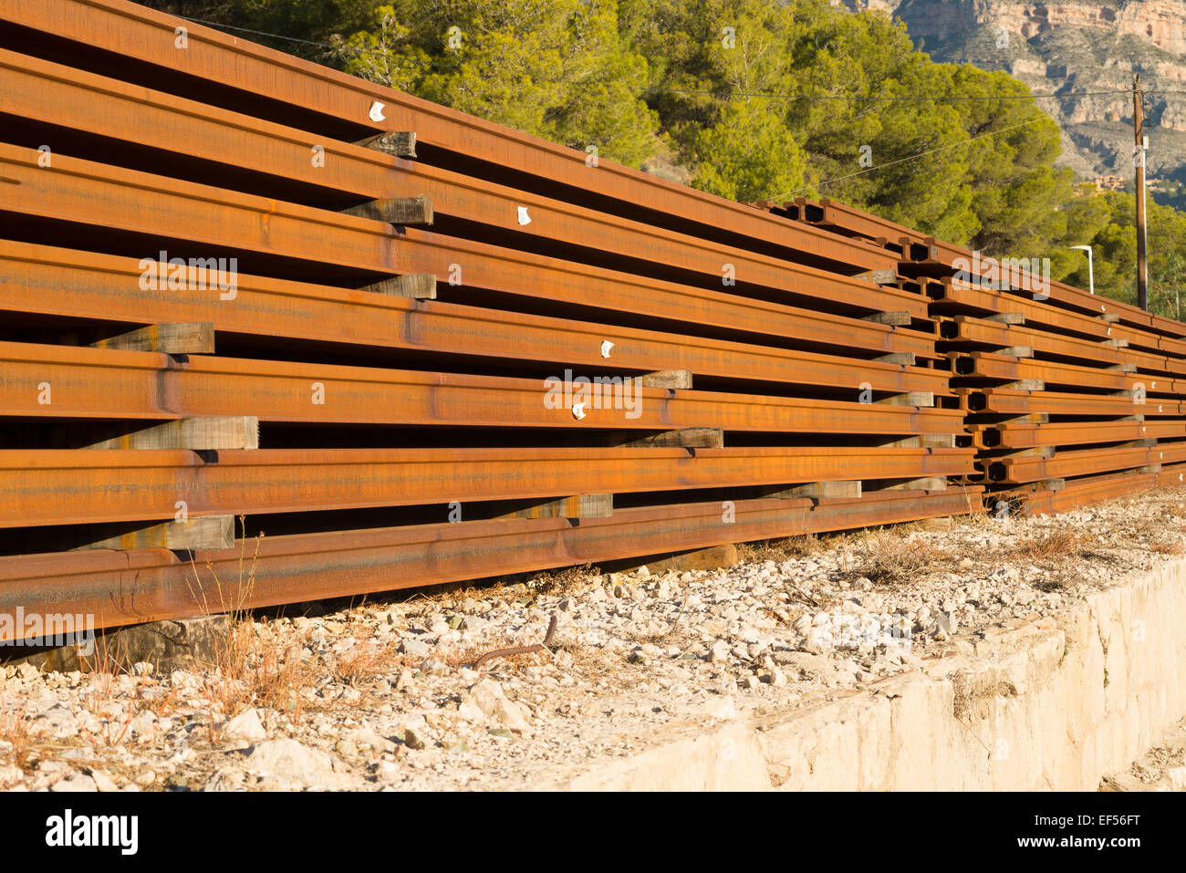 New rails piled up at a railroad construction site Stock Photo - Alamy