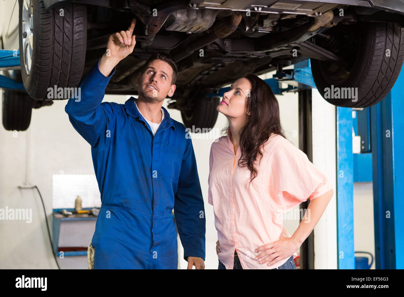 Mechanic showing customer the problem with car Stock Photo - Alamy