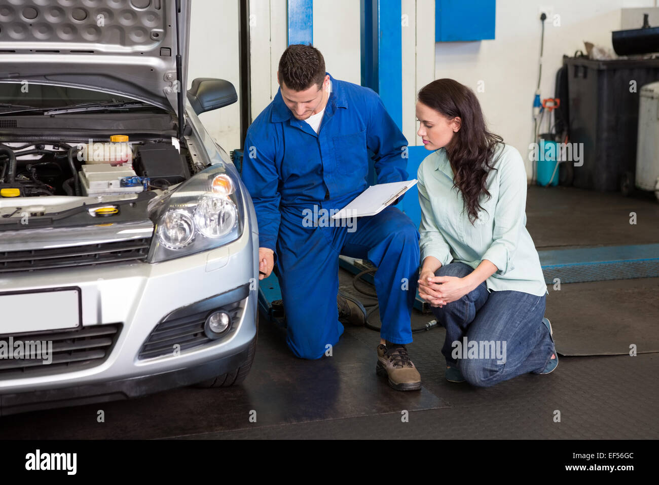 Mechanic showing customer the problem with car Stock Photo - Alamy