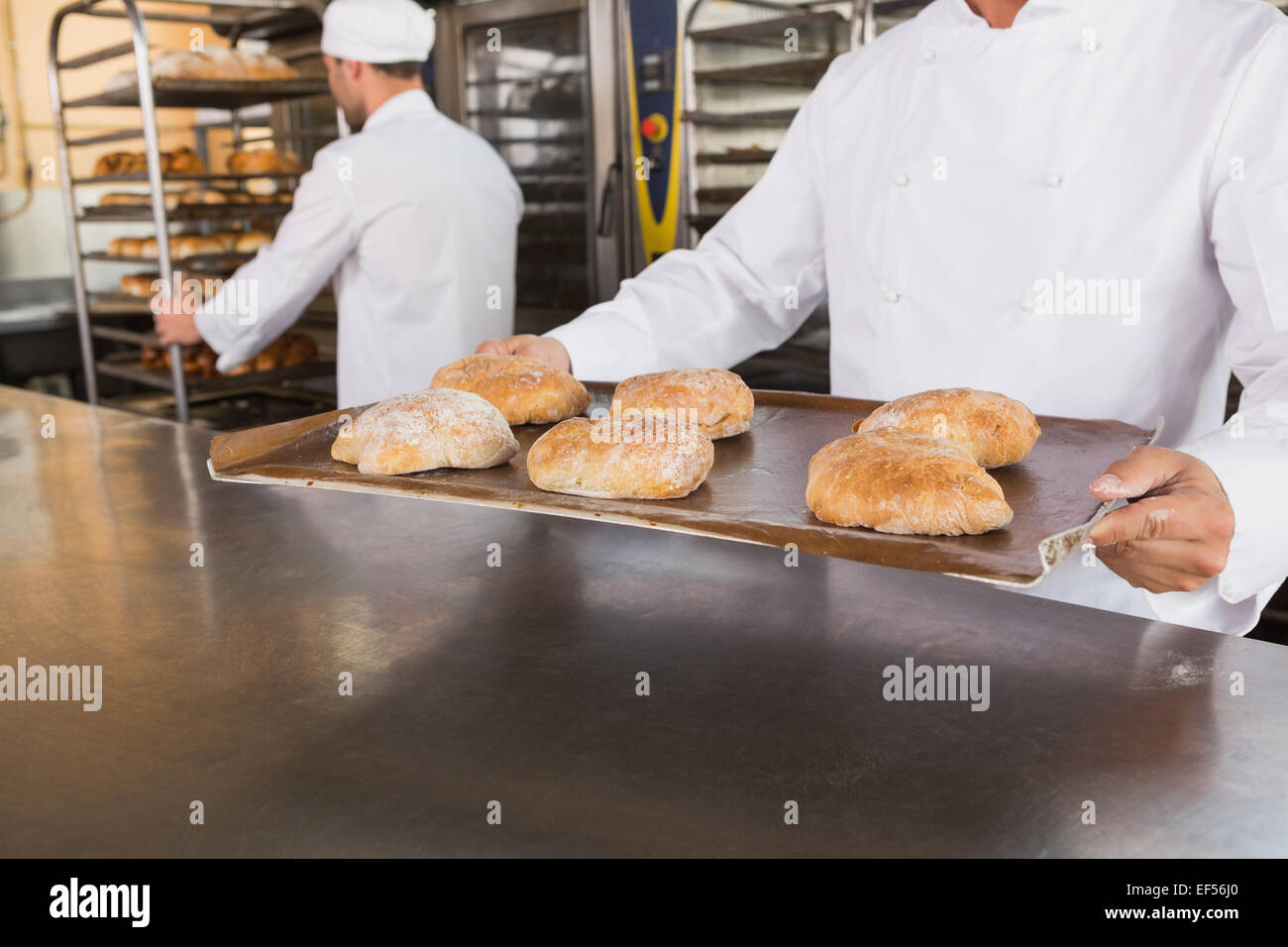 Close up of baker holding tray of bread Stock Photo - Alamy