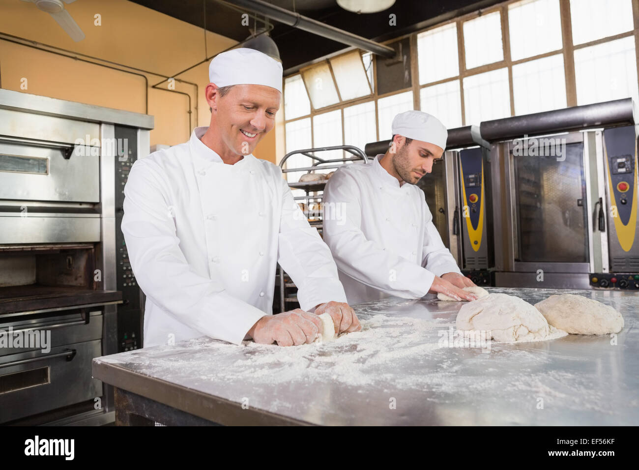 Happy bakers making dough hi-res stock photography and images - Alamy