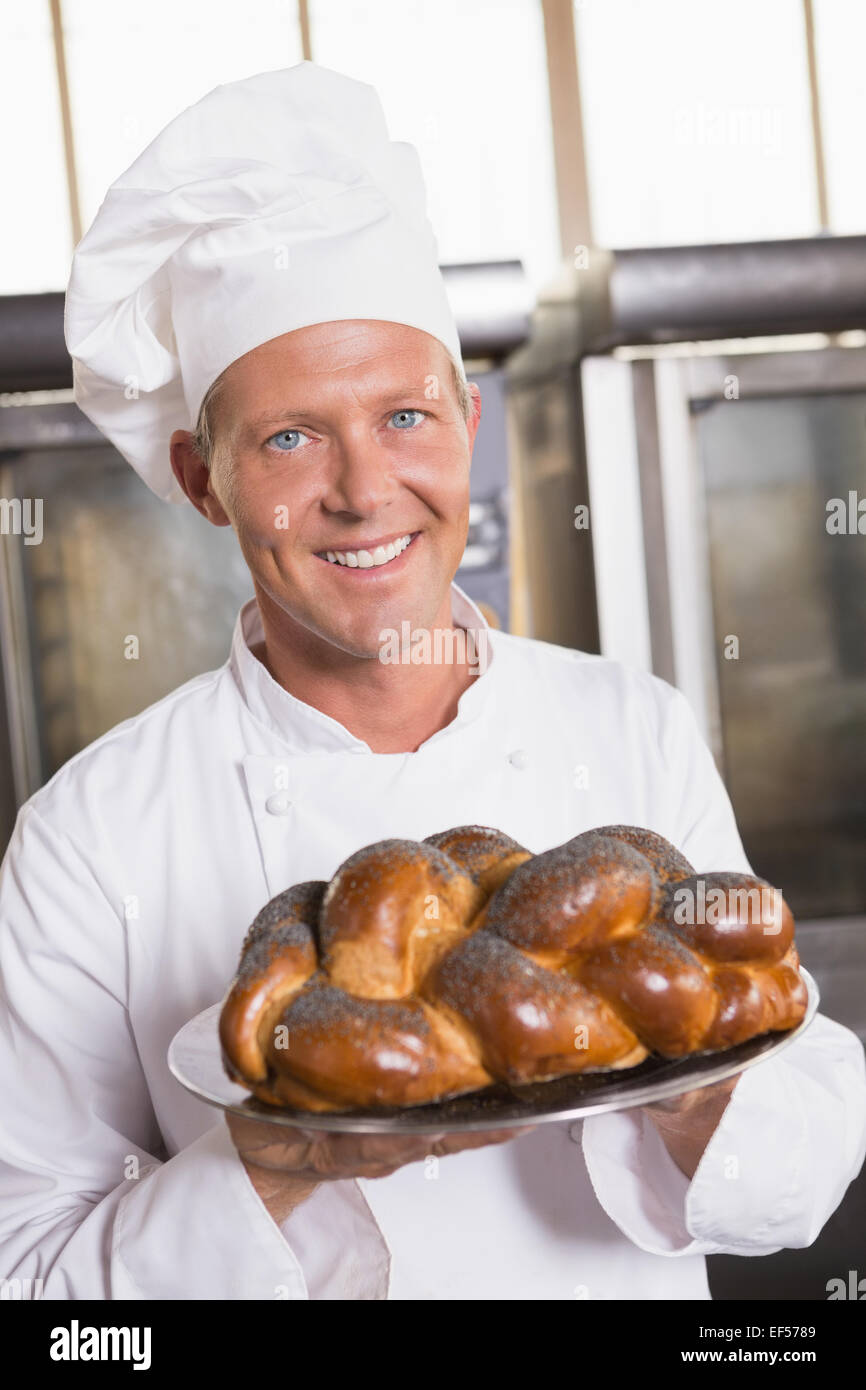 Baker showing freshly baked loaf Stock Photo - Alamy