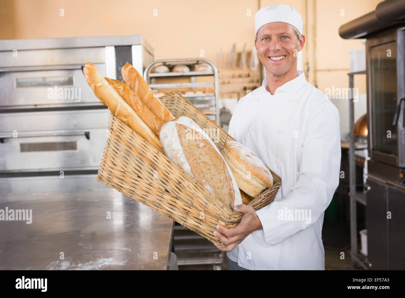 Baker showing basket of bread Stock Photo - Alamy