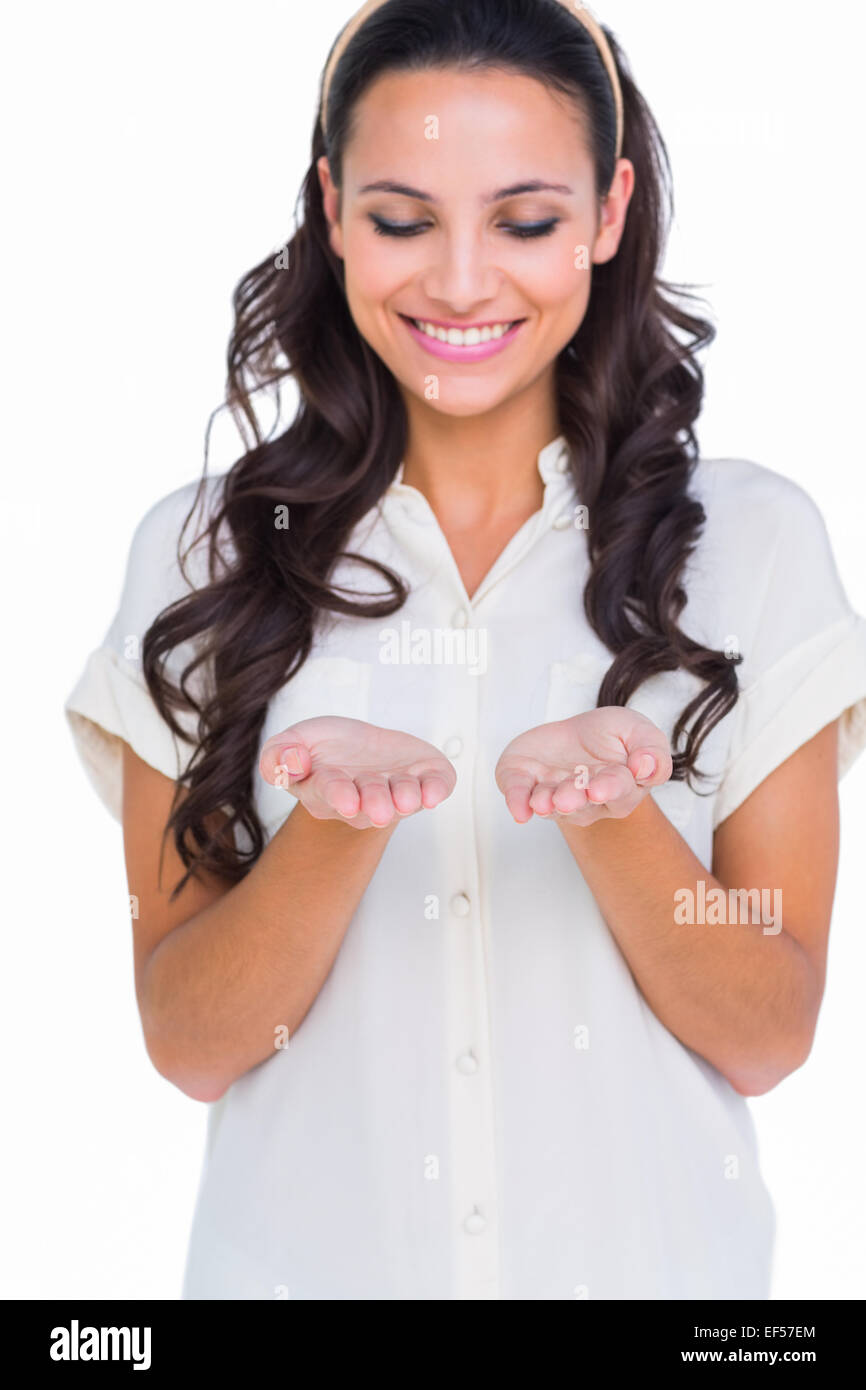 Pretty brunette holding out hands Stock Photo - Alamy