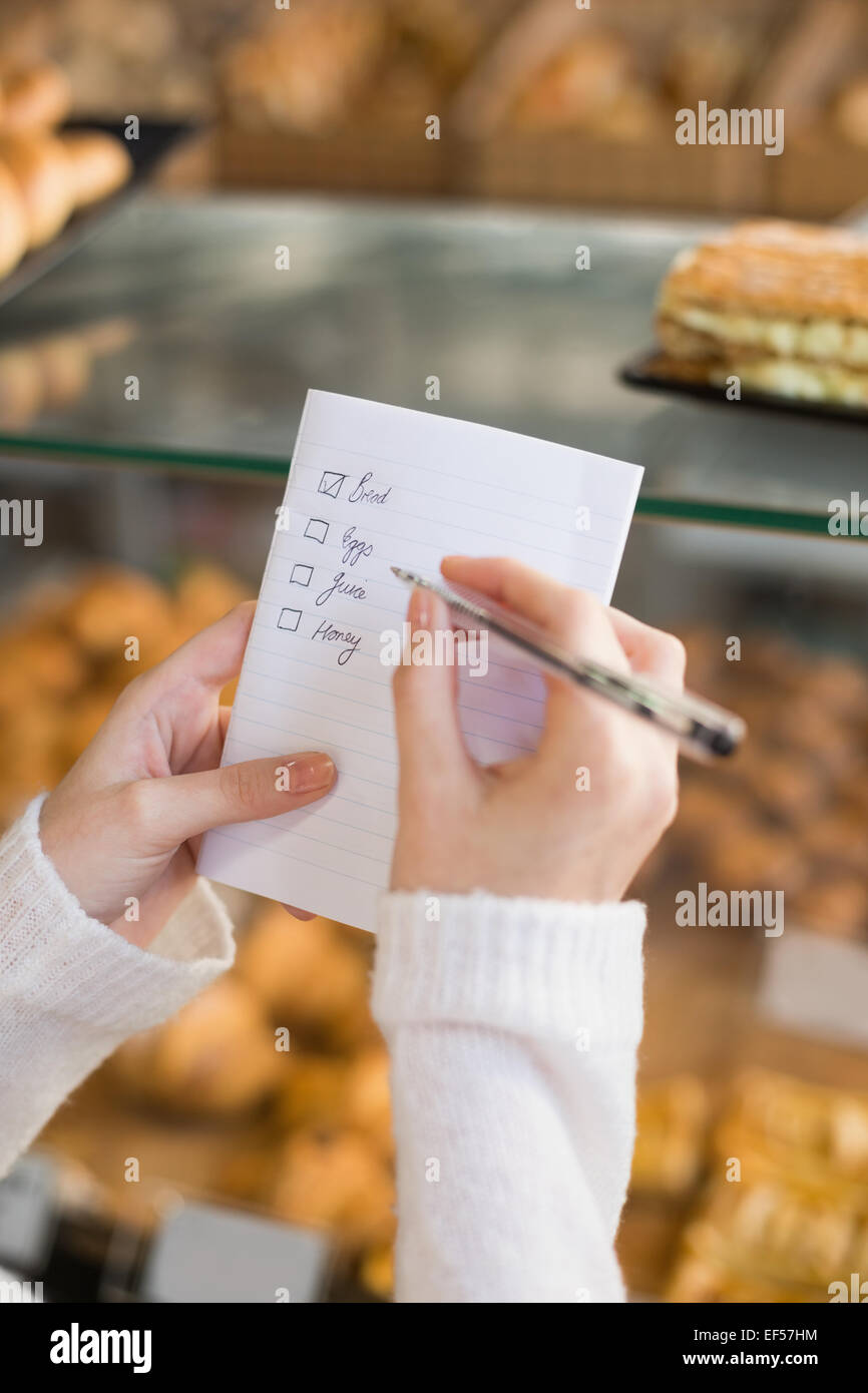 Woman checking her shopping list Stock Photo - Alamy