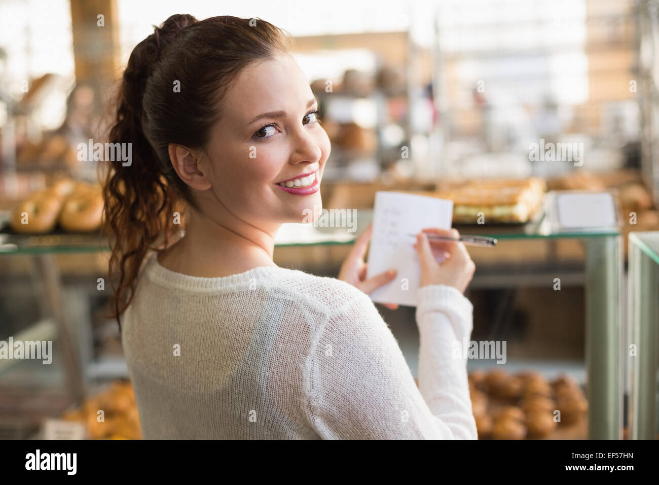 Woman checking her shopping list Stock Photo - Alamy